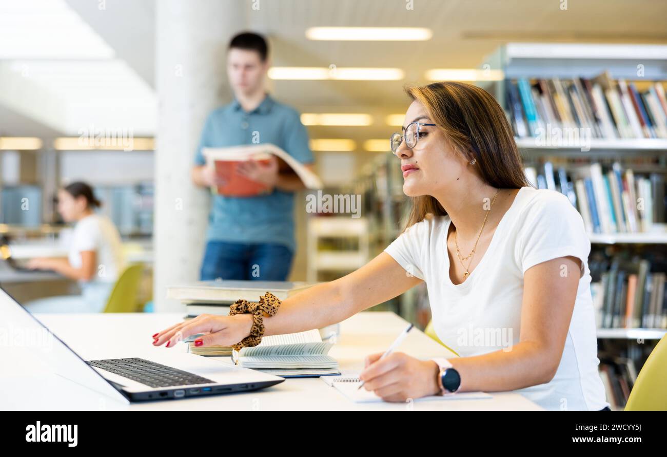 Mexican school student girl doing research on project Stock Photo - Alamy