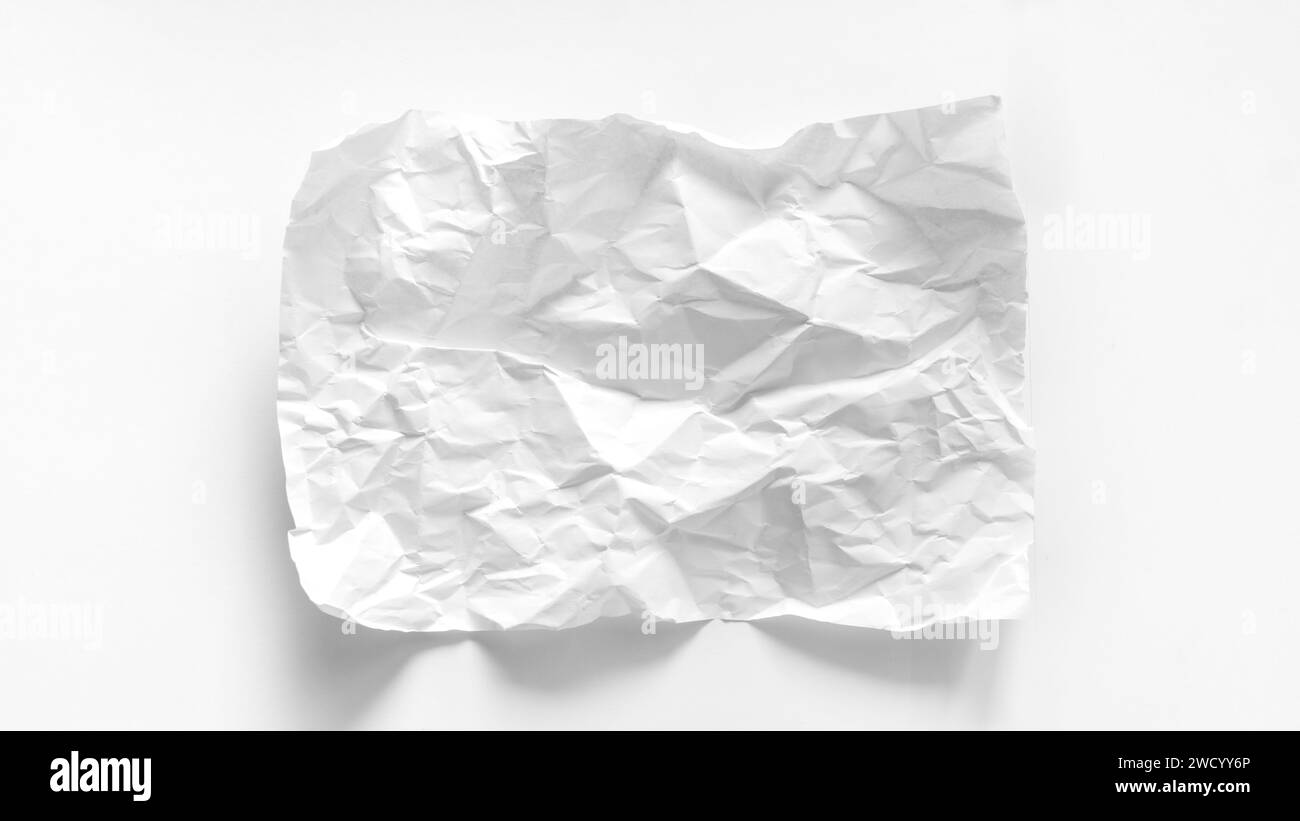 A heavily crumpled sheet of white paper close-up with copy space ...