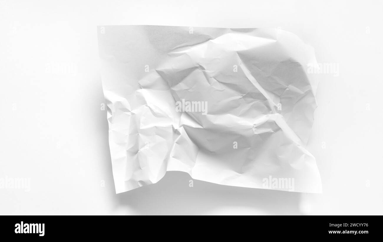 Crumpled sheet of A4 paper on a white background with copy space ...