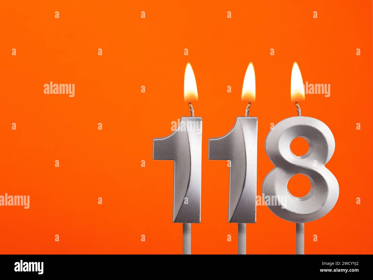 Candle number 118 - Birthday in orange background Stock Photo - Alamy