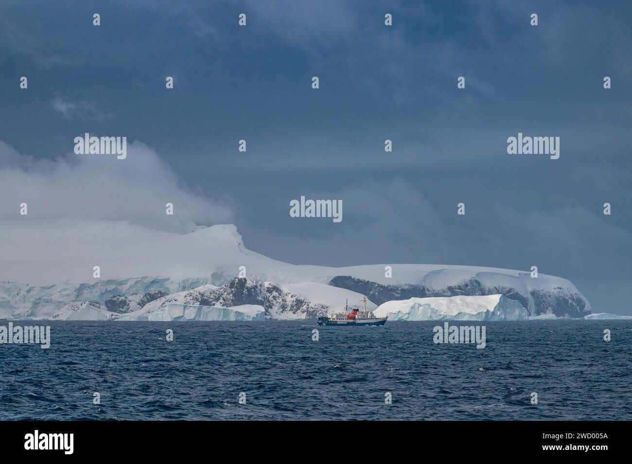 Ship and icebergs Brialmont Cove, Antarctica, Antarctic peninsula ...