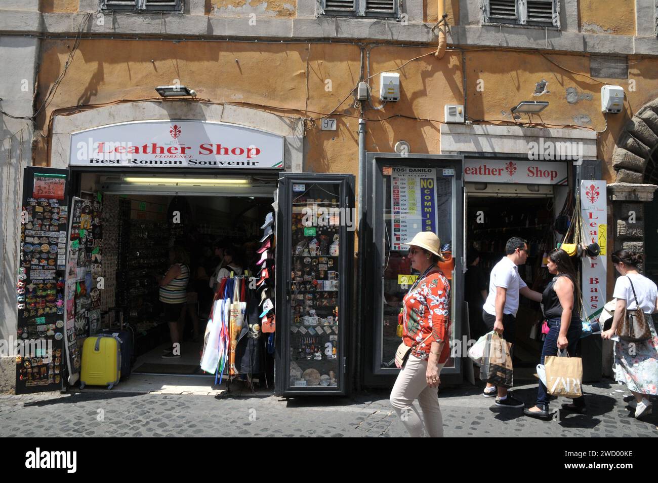Rome / Italy 17.July 2019/ consumers and shoppeers walk by and ...