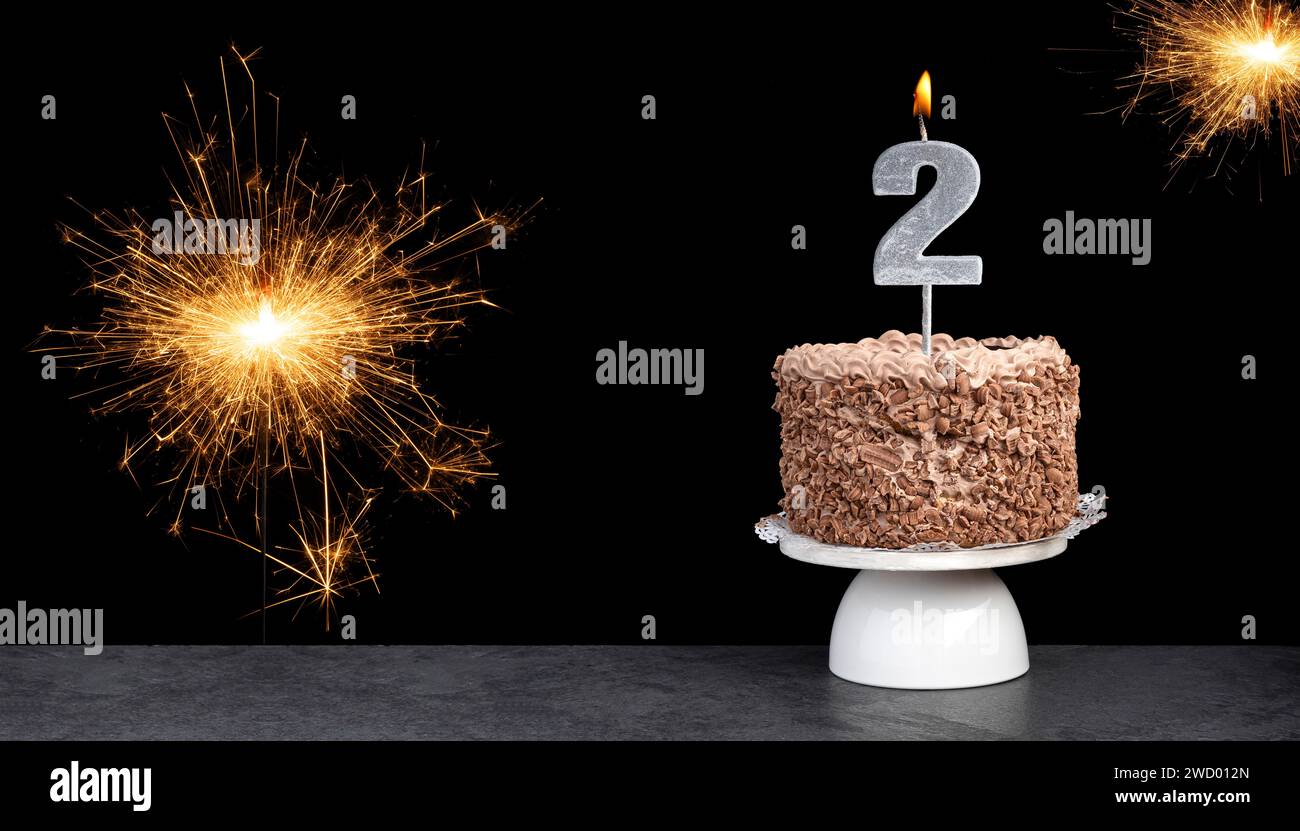 Birthday celebration with cake and candle number 2 Stock Photo - Alamy