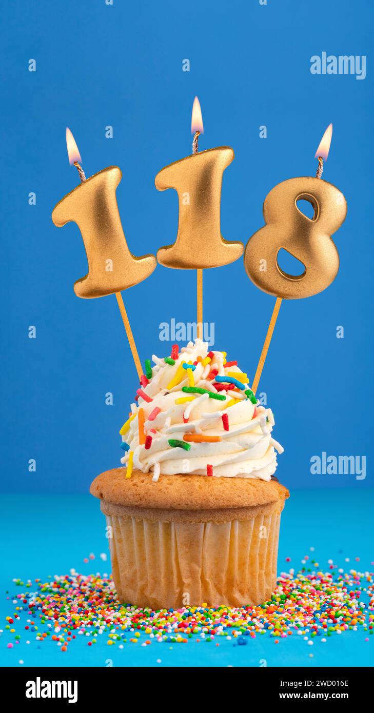 Birthday cake with candle number 118 - Blue background Stock Photo - Alamy