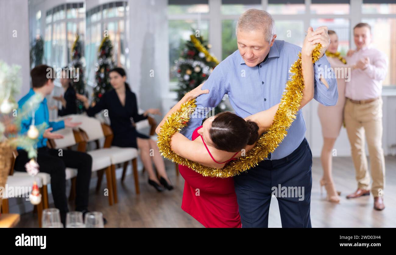 Christmas and New Year holiday - couples dancing with tinsel near ...