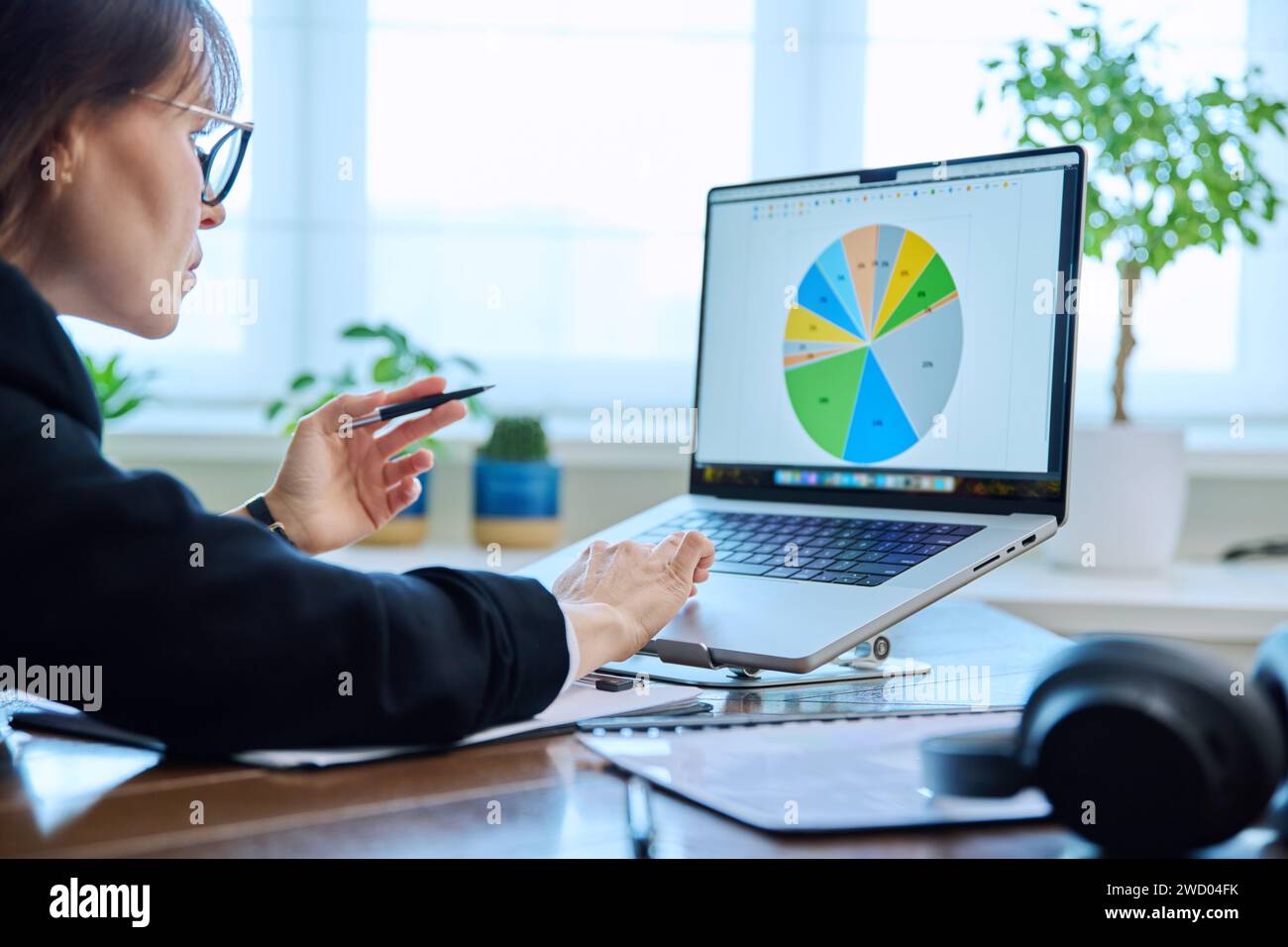 Mature serious business woman working at computer, workplace boss ...