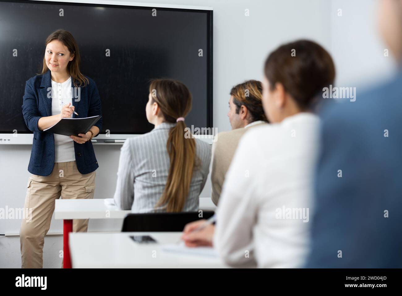 Positive successful woman near interactive board conducting business ...