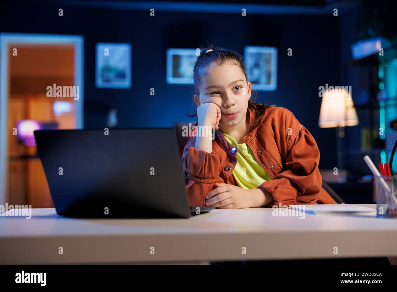 Tired little girl filming with professional gear in living room used as ...