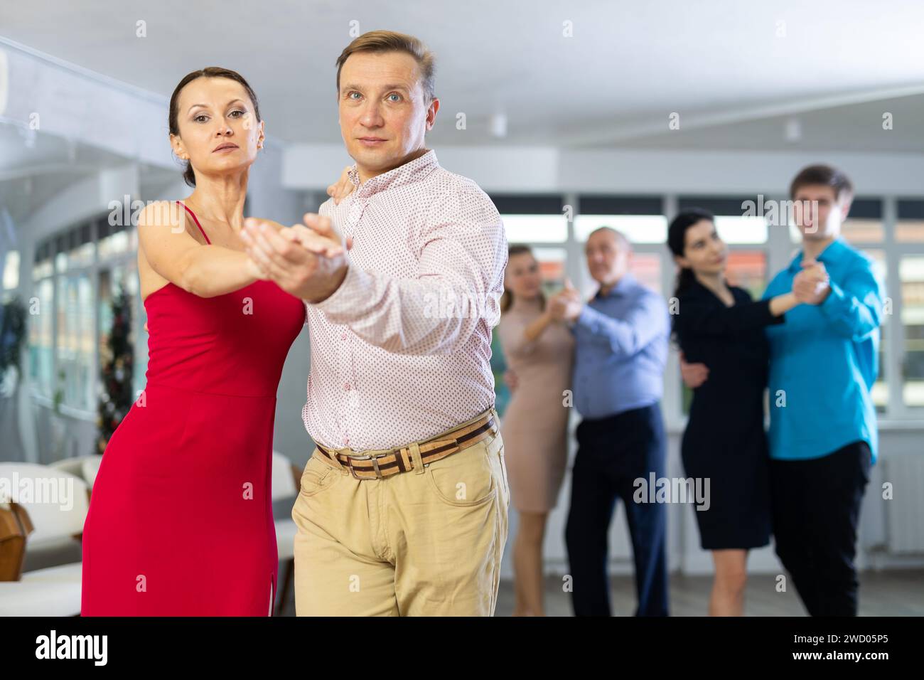 Adult couple enjoying slow foxtrot in dance studio Stock Photo - Alamy