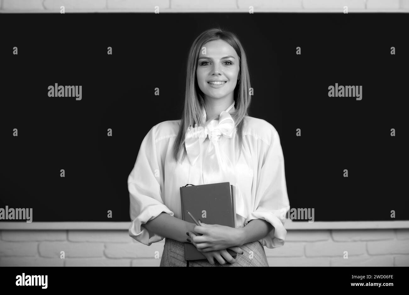 Student holding book, preparing exam and learning lessons in school ...