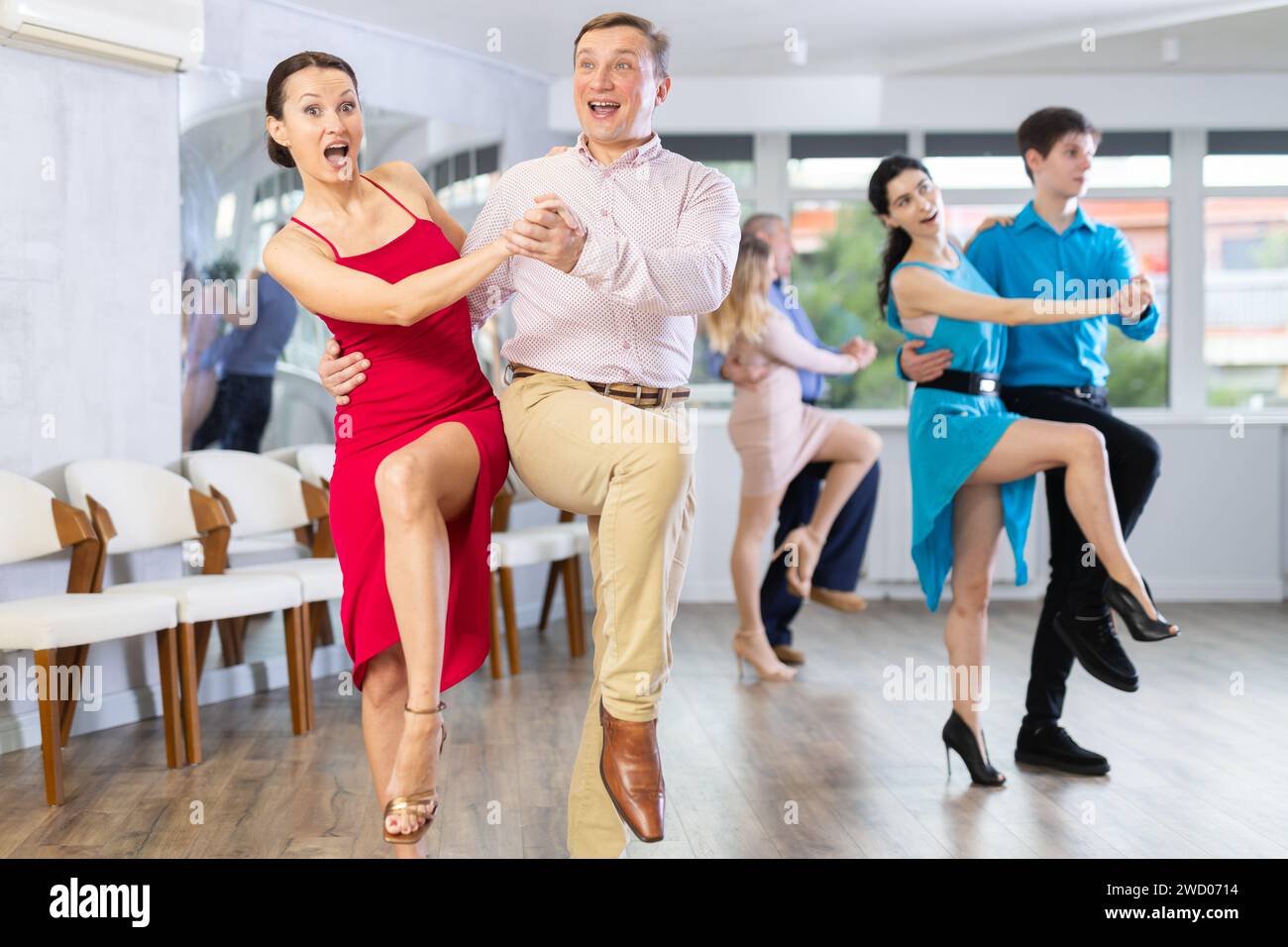 Dynamic pair engaging in Latino dance in dance studio. Pairs training ...