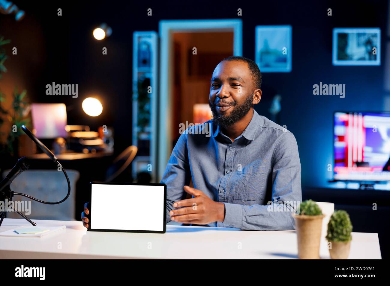 Man filming tech tutorial on how to repair broken mockup tablet ...