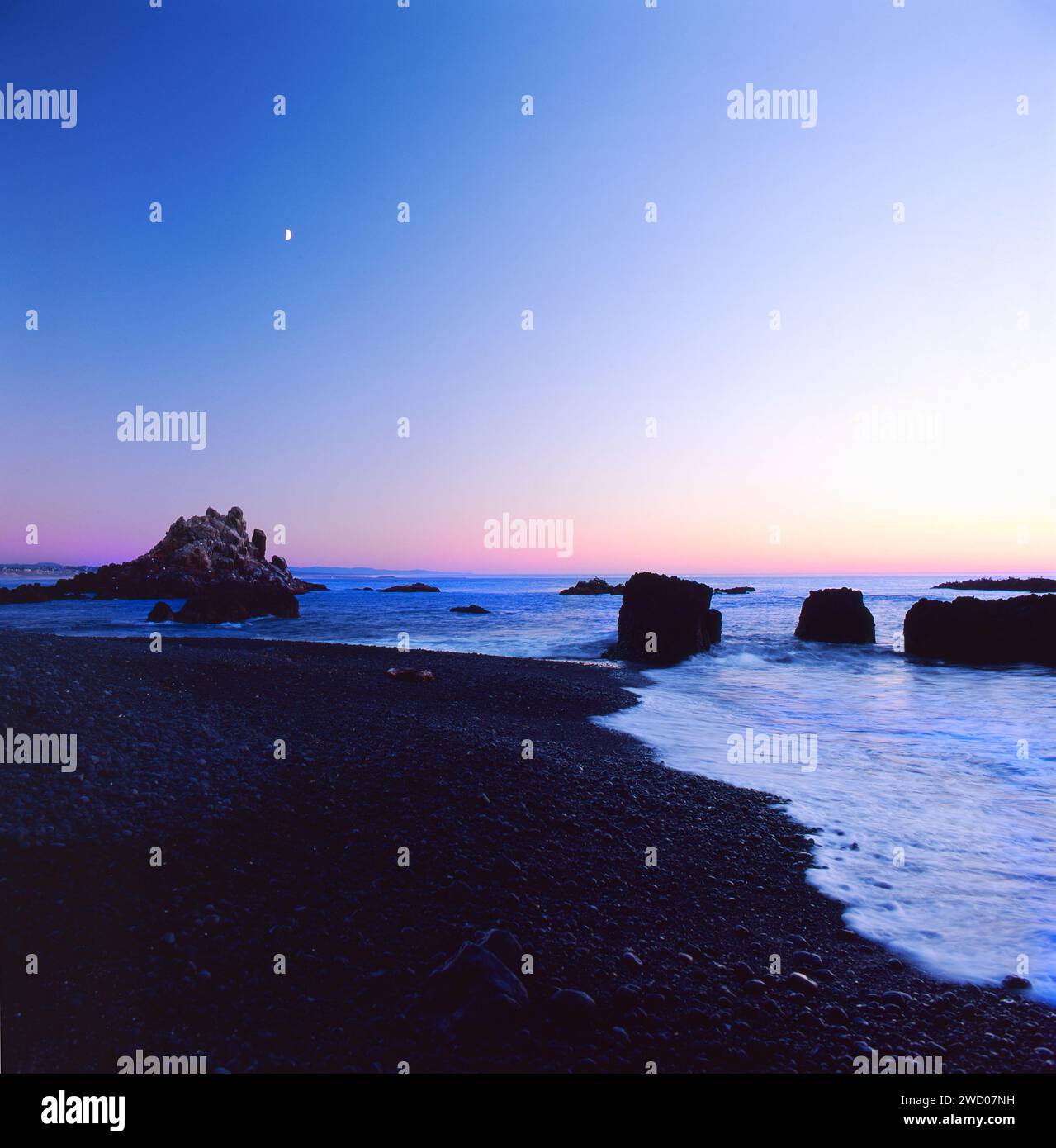 Crescent moon rising over pacific ocean near Yaquina Head; Oregon; USA ...
