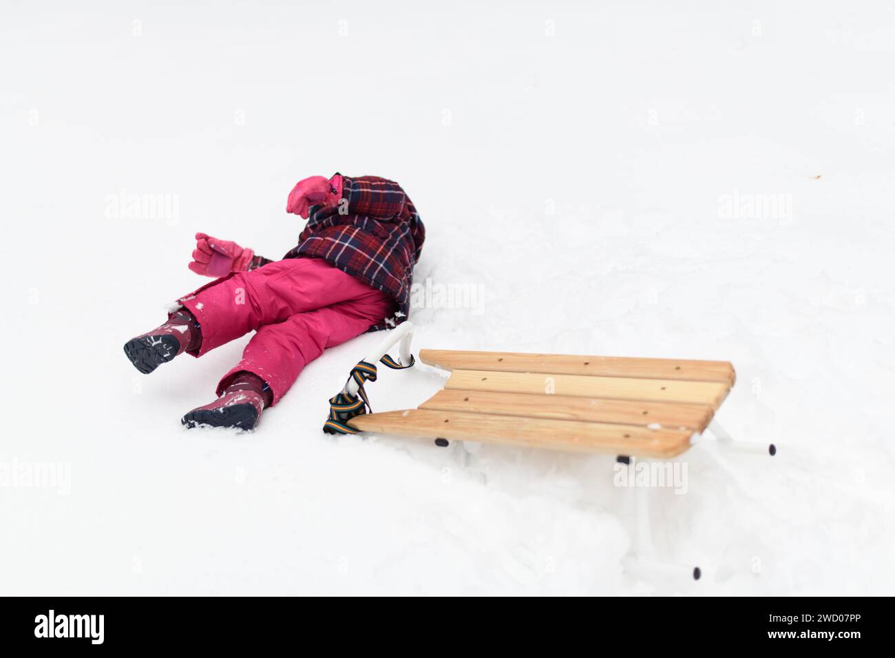 Little Girl Playing in Woods Sledge and Falling From Stock Photo - Alamy