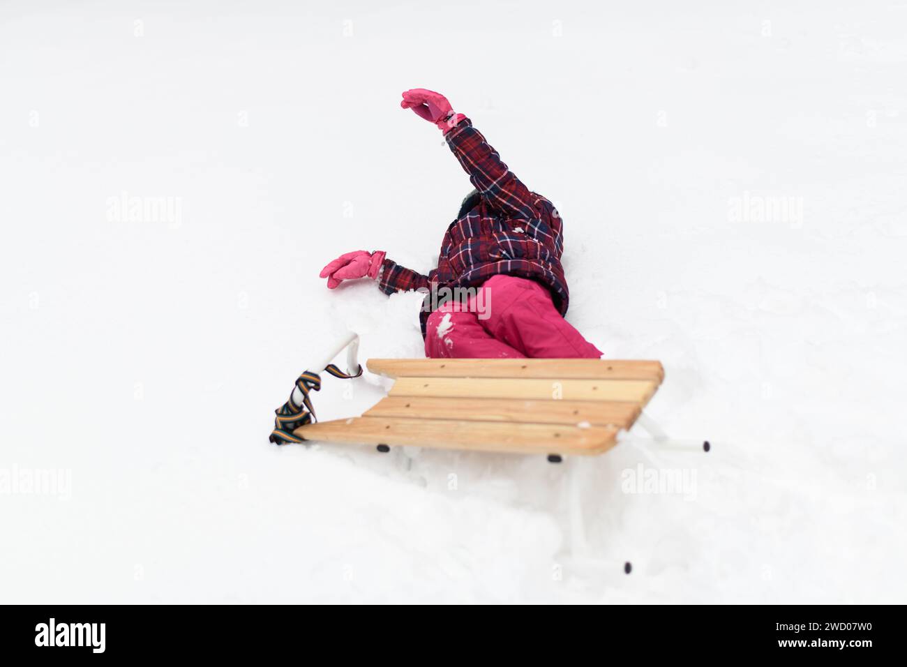 Little Girl Playing in Woods Sledge and Falling From Stock Photo - Alamy