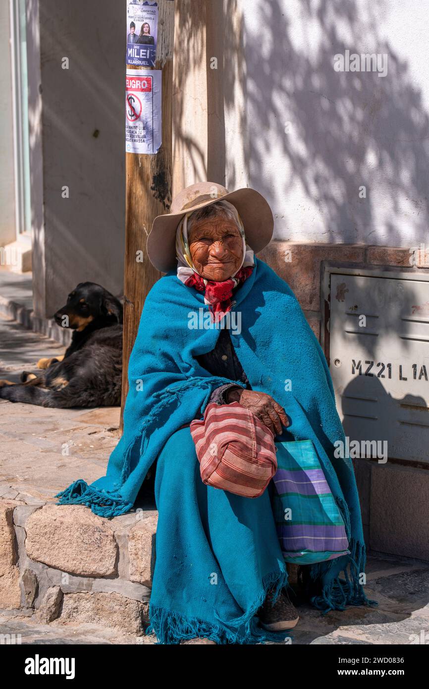 Old woman wearing a traditional andes blue poncho on the steet at San ...