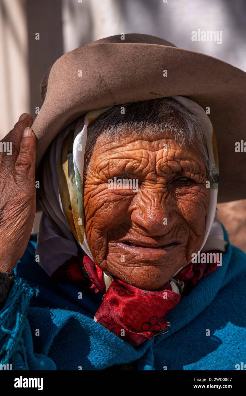 Old woman wearing a traditional andes blue poncho on the steet at San ...