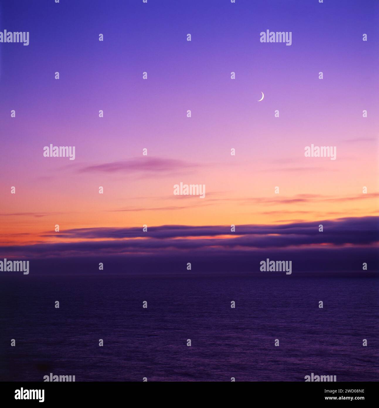 Crescent moon rising over pacific ocean near Yaquina Head; Oregon; USA ...