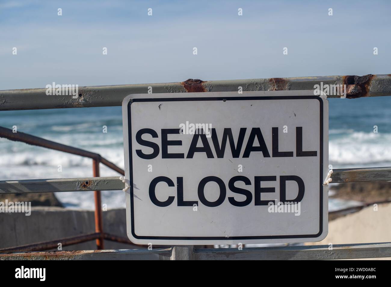 Seawall closed sign on a beach Stock Photo - Alamy