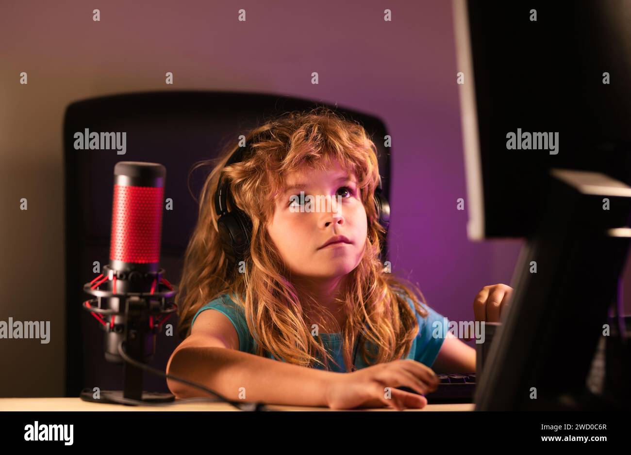 Kid using pc at night. Child with computer in a dark room. School, study, online learning ...