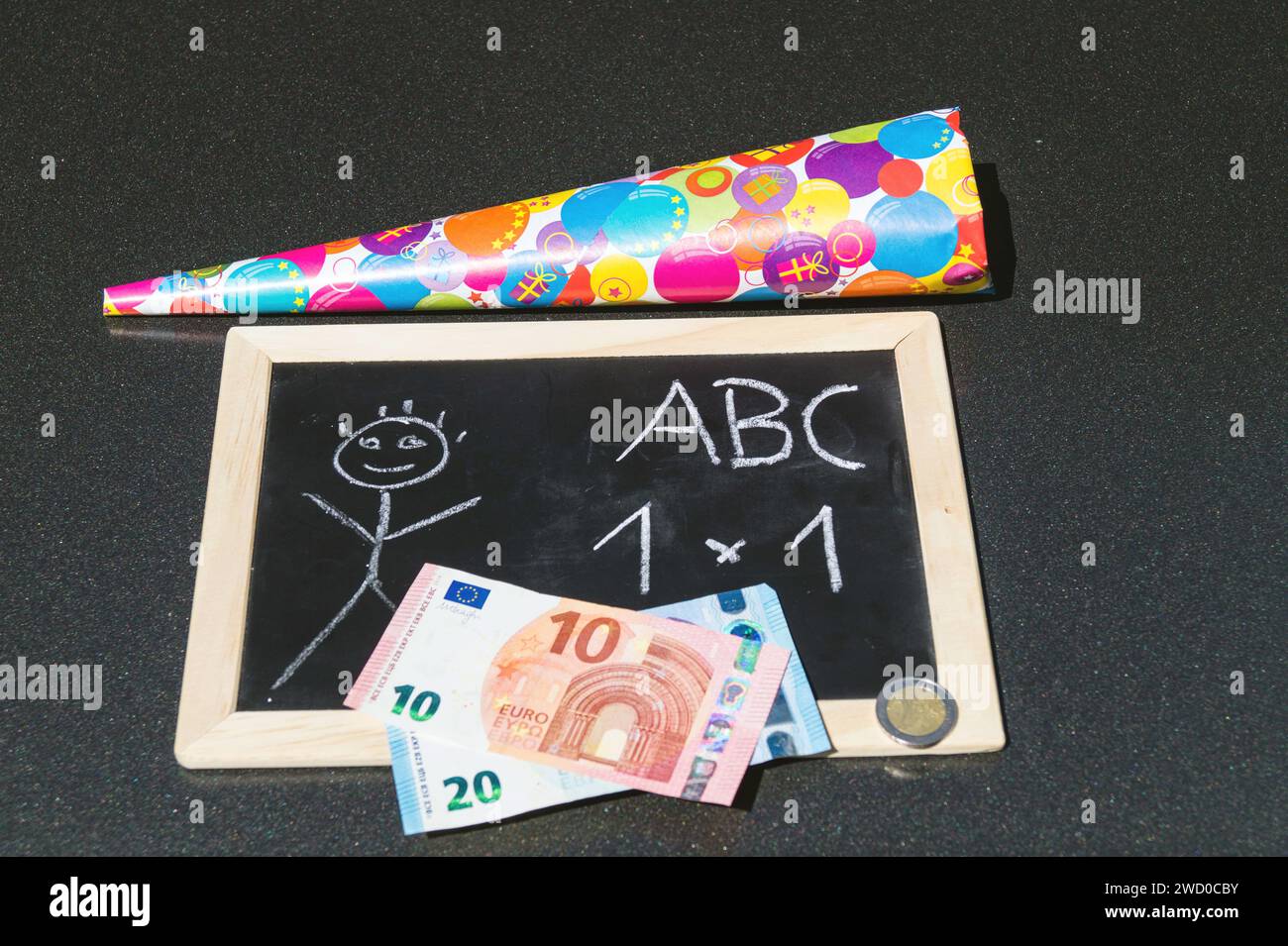 school cone, slate and money, symbolic image for school fees Stock ...