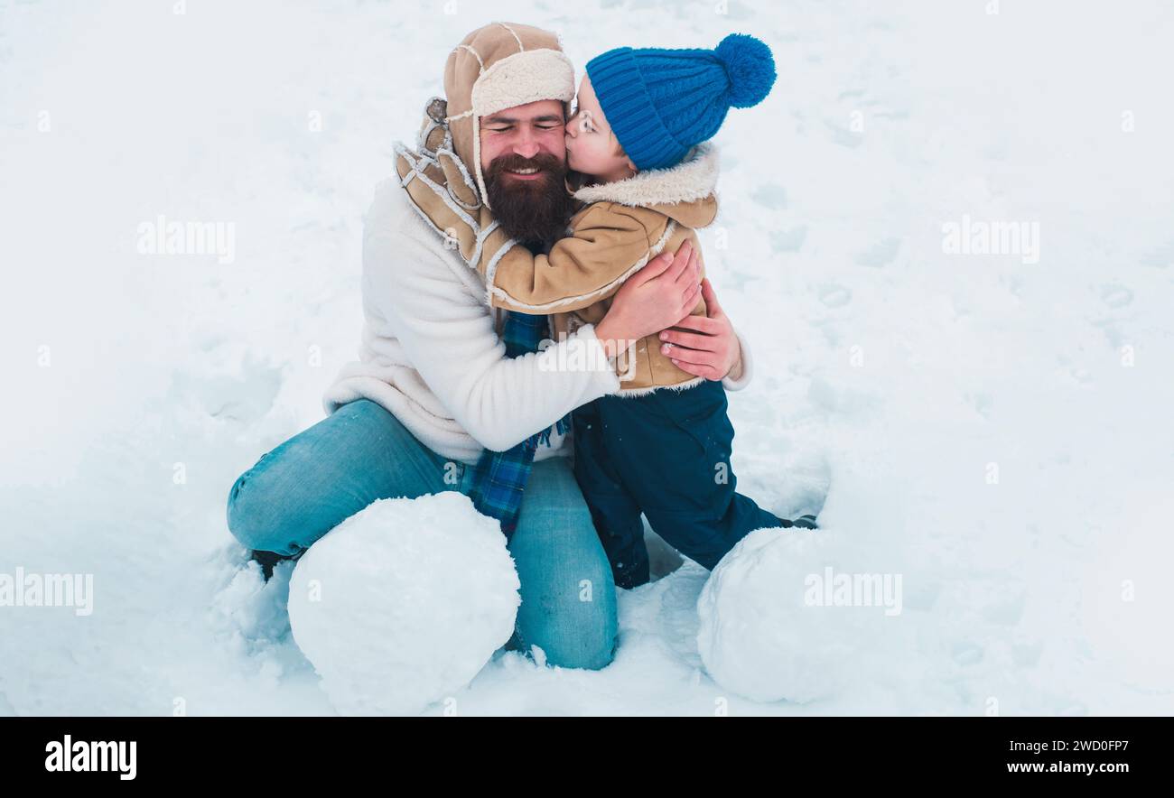 Daddy and son smiling and hugging. Best winter game for happy family ...