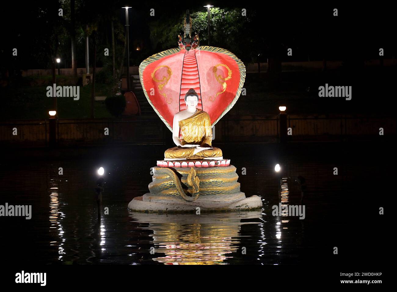 Image of the Buddha seating in meditation, under the protective hood of ...