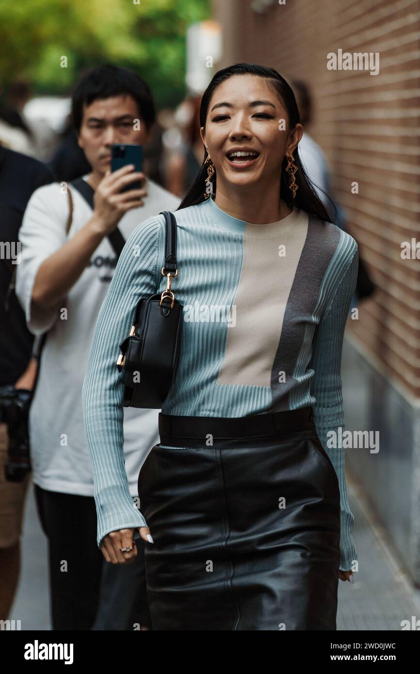 Yuwei Zhangzou wears black leather skirt, light mint green and white ...