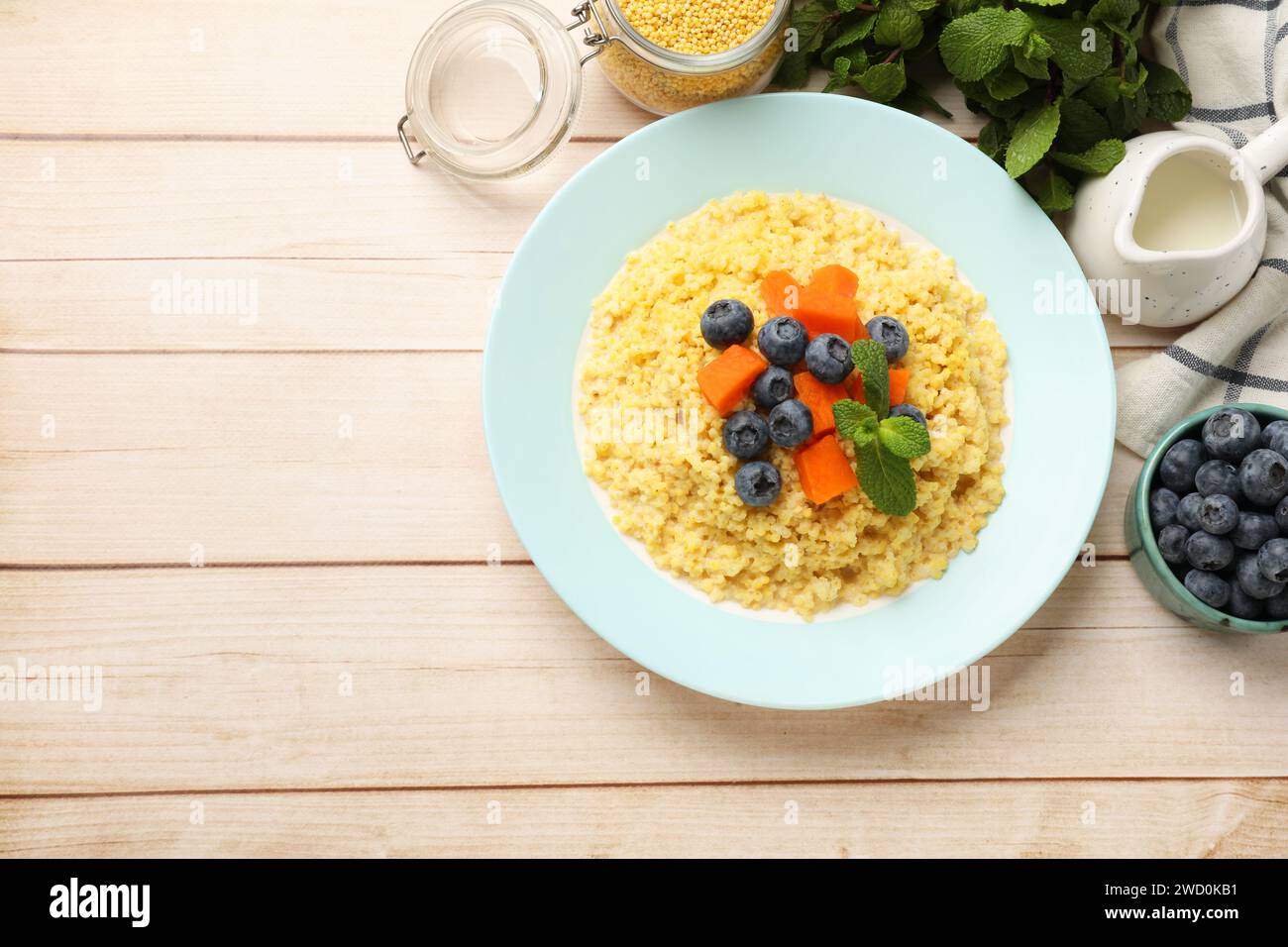 Plate with tasty millet porridge, blueberries, pumpkin and mint on ...