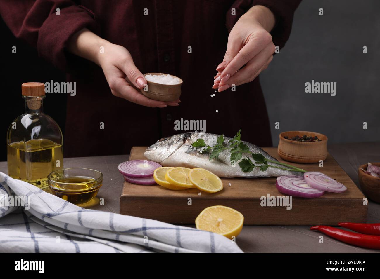 Woman salting raw dorado hi-res stock photography and images - Alamy