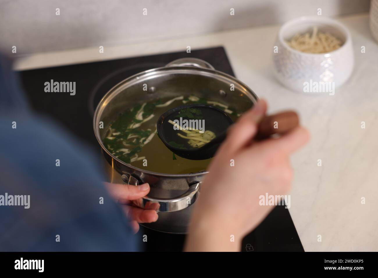 Woman cooking soup hi-res stock photography and images - Alamy