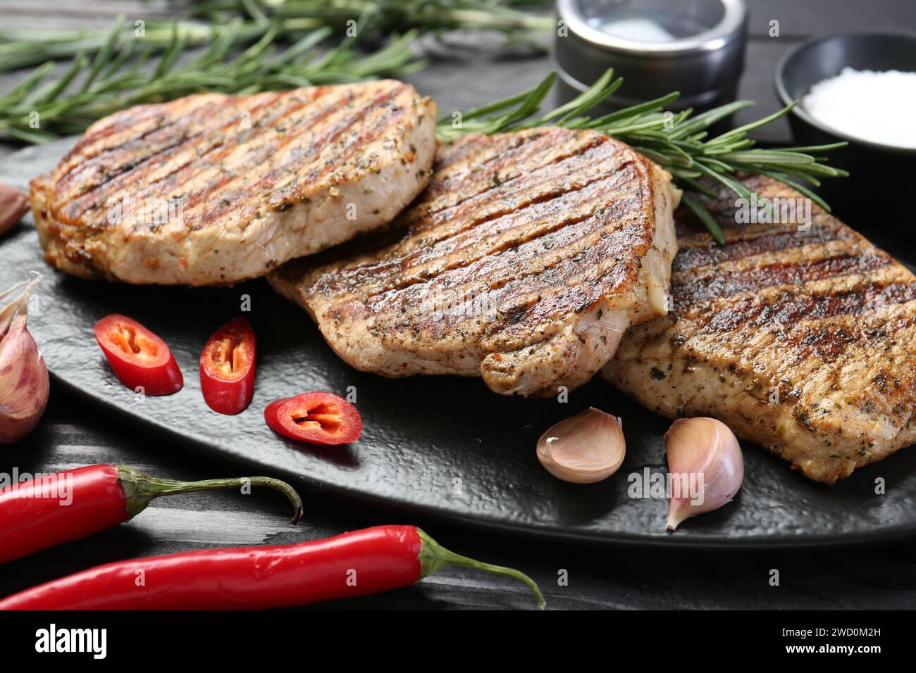 Delicious grilled pork steaks with spices on table, closeup Stock Photo ...