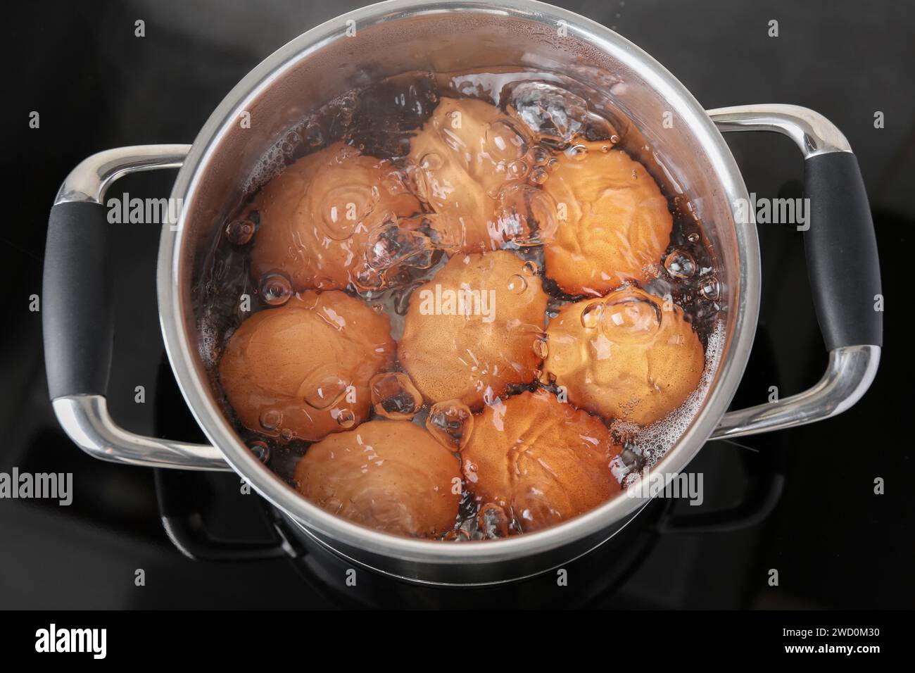 Chicken eggs boiling in pot on electric stove, top view Stock Photo - Alamy
