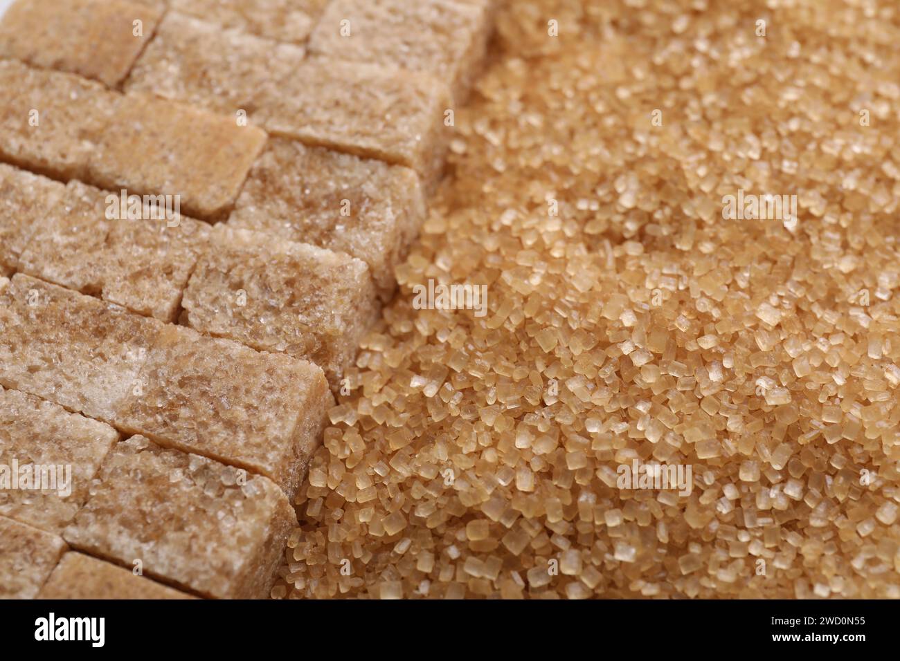Different types of brown sugar as background, closeup. Space for text ...