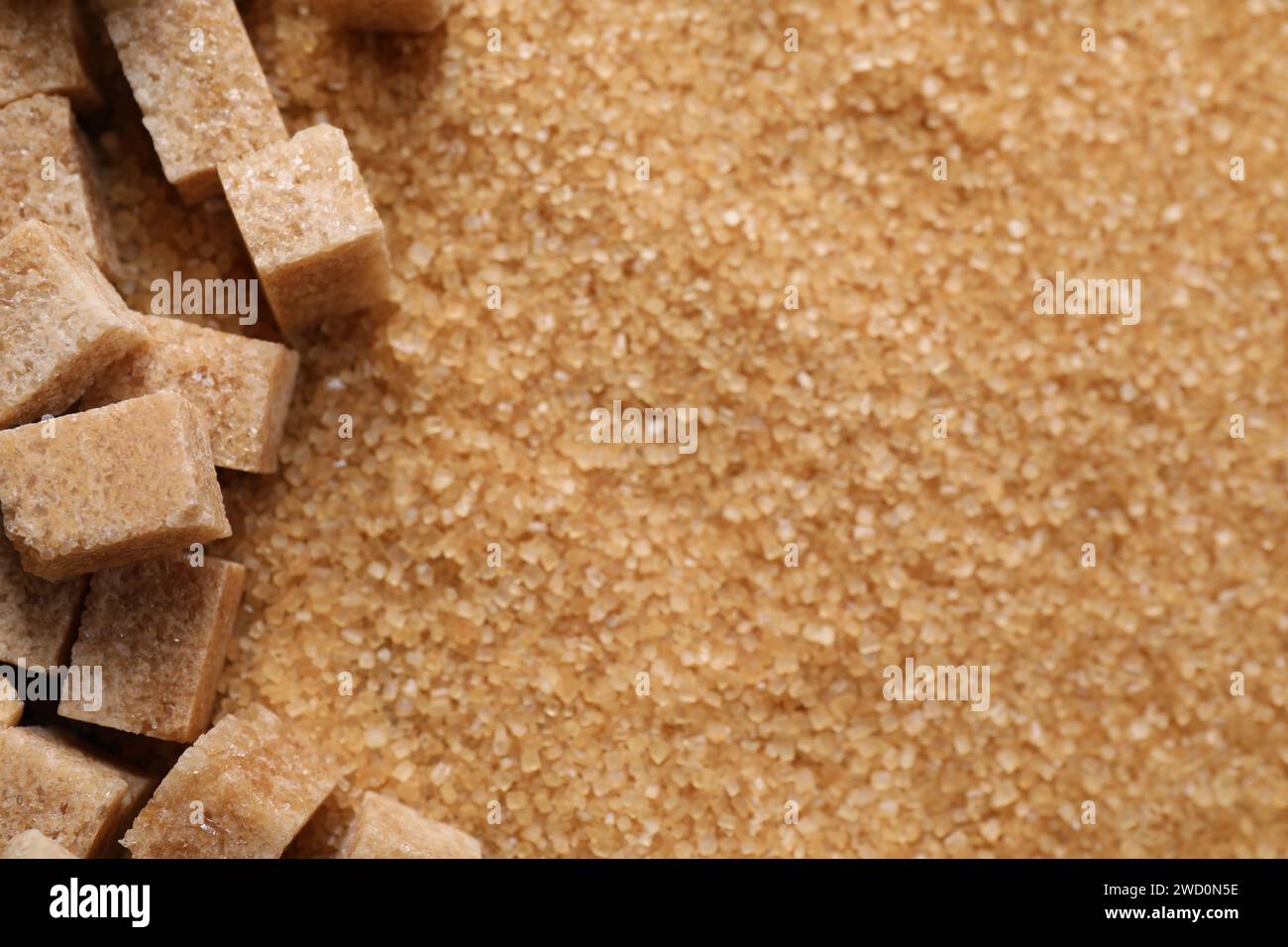 Different types of brown sugar as background, top view. Space for text ...