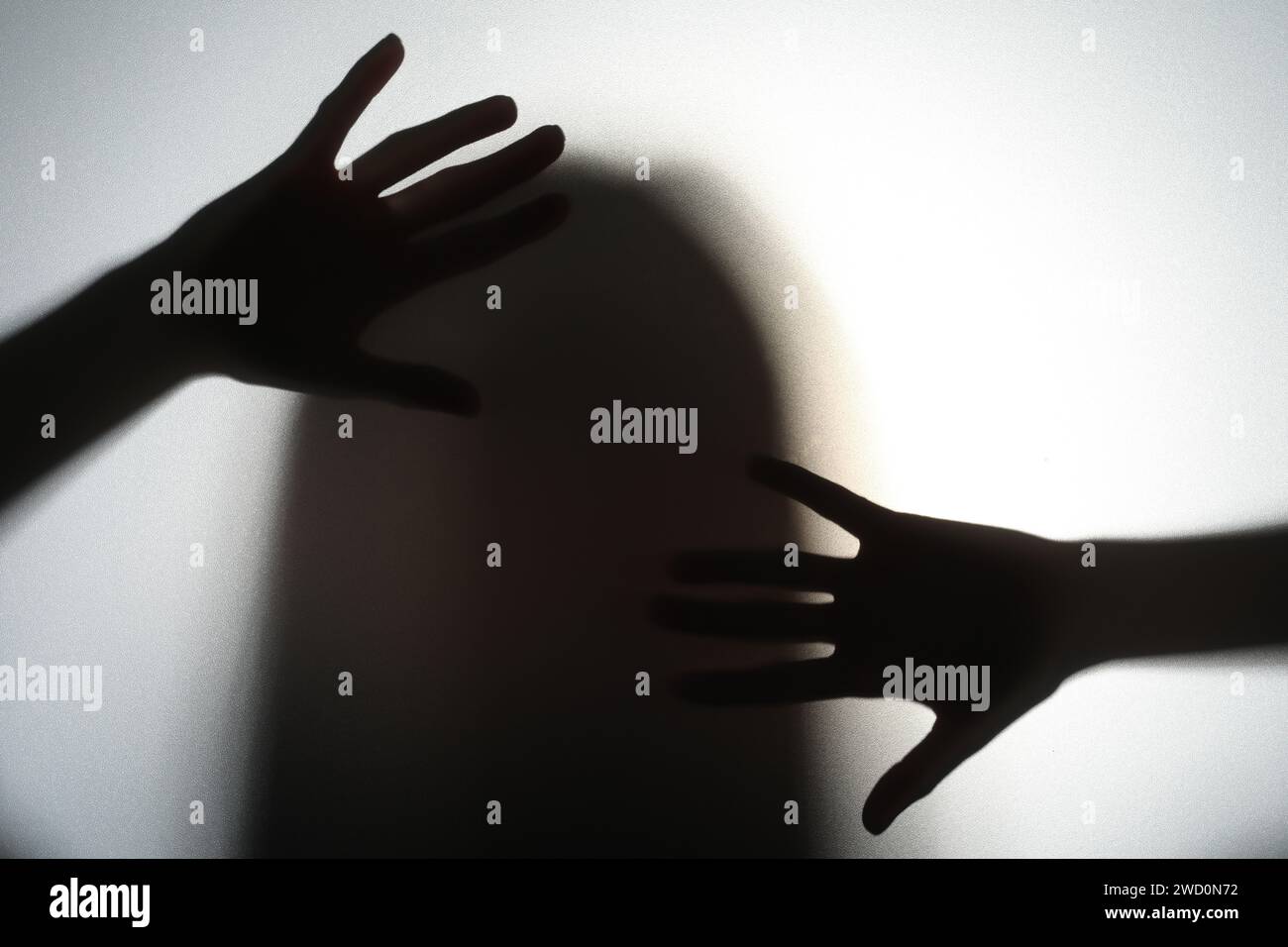 Silhouette of creepy ghost behind glass against white background Stock ...