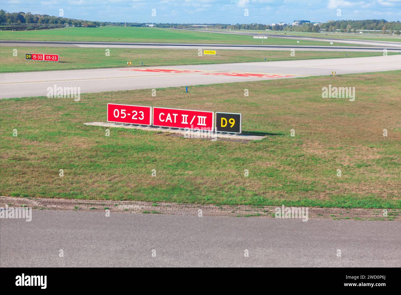 View of the runway with road signs for airline pilots Stock Photo - Alamy