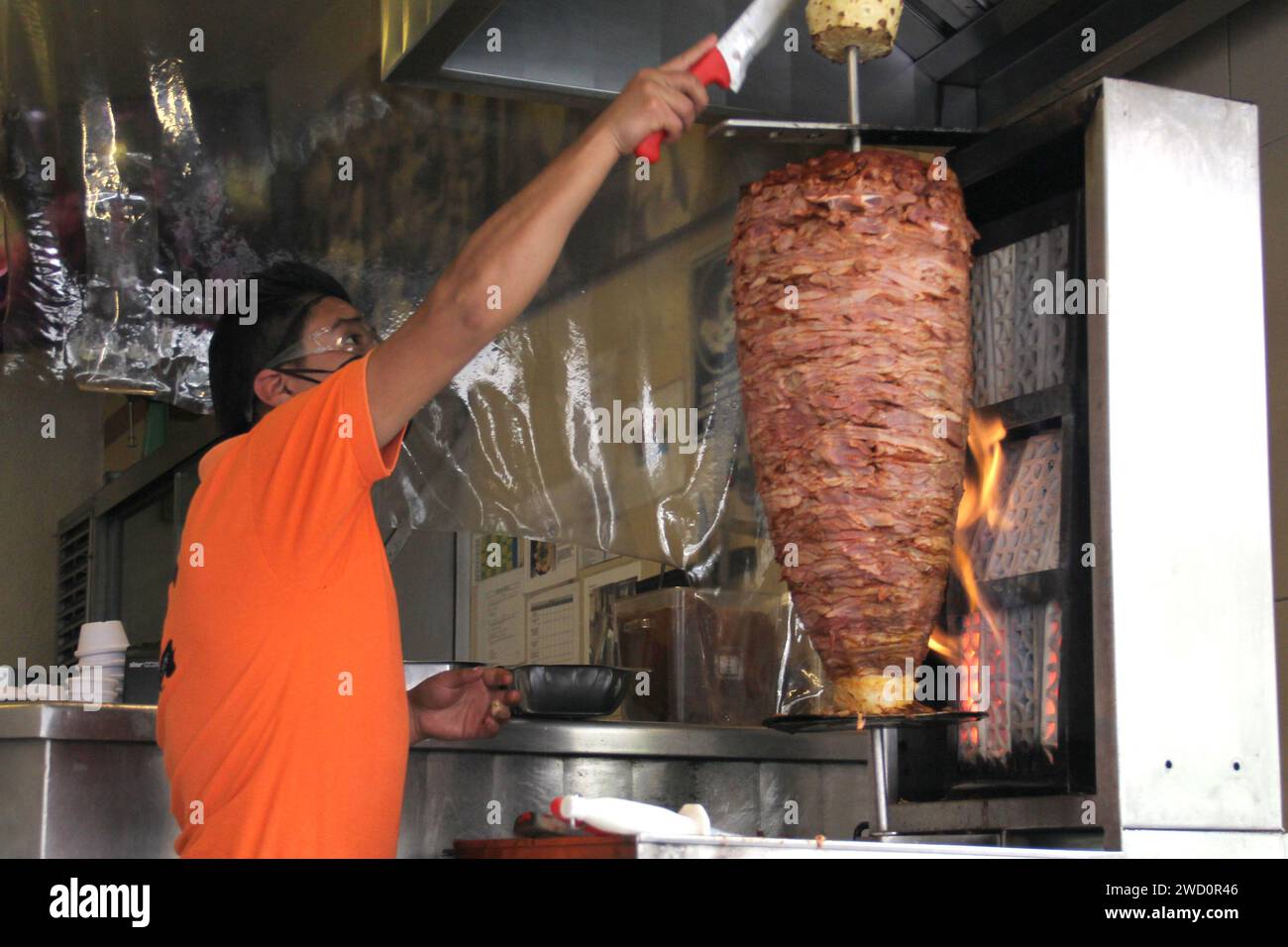 Latino taquero man working with protection mask, typical mexican food ...