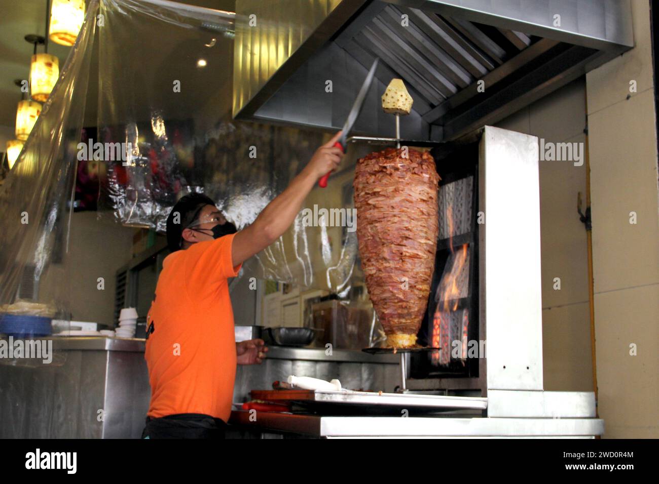 Latino taquero man working with protection mask, typical mexican food ...