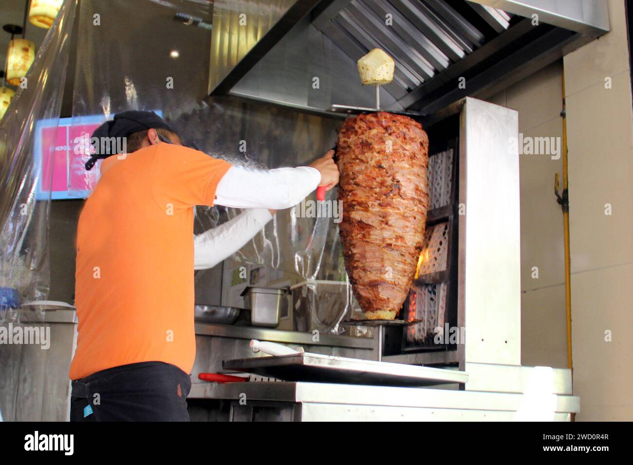 Latino taquero man working with protection mask, typical mexican food ...