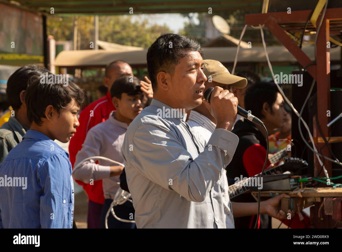 Bagan, Myanmar - 25 Dec, 2019: A Burmese man sings into a microphone ...