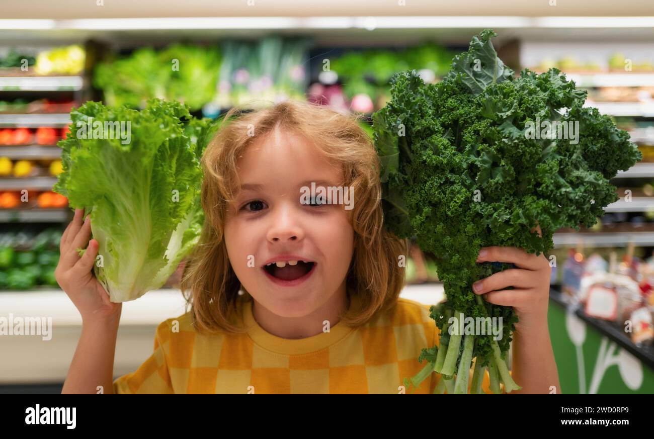 Child with lettuce chard vegetables. Little child choosing food in ...
