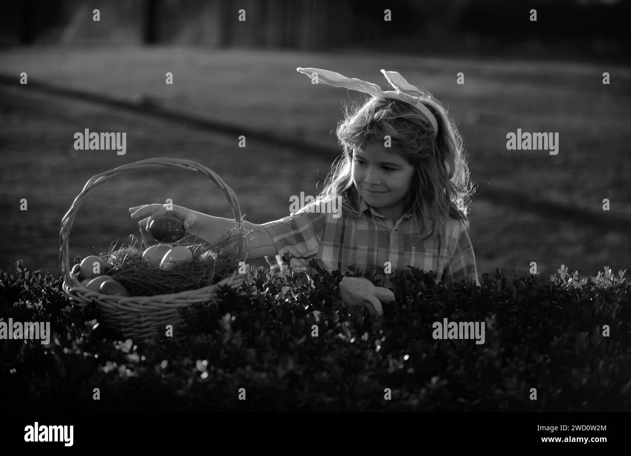 Kids boy hunting easter eggs in park. Child bunny boy with rabbit bunny ...