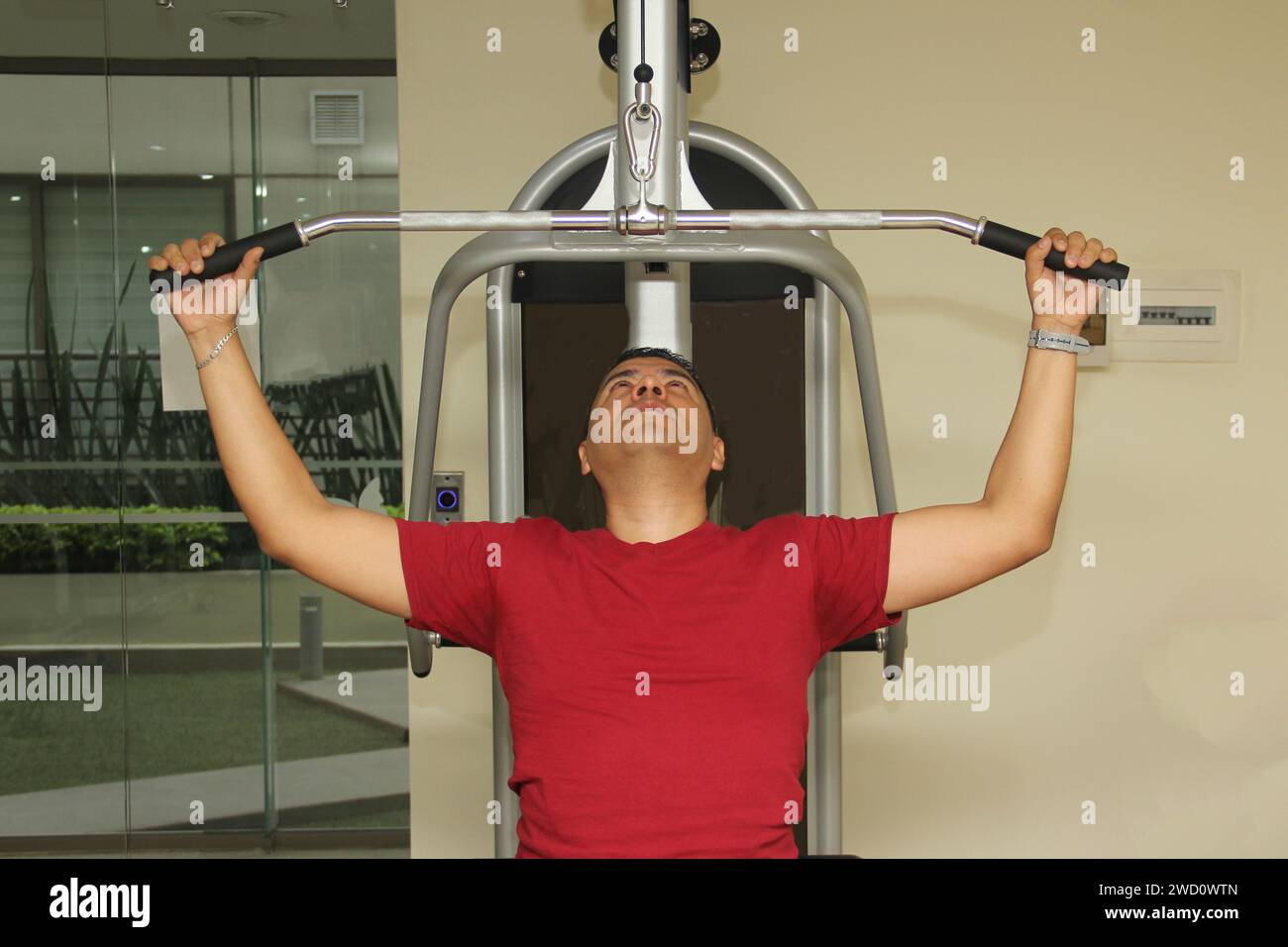 40-year-old dark-skinned Latin man does exercises to strengthen chest ...