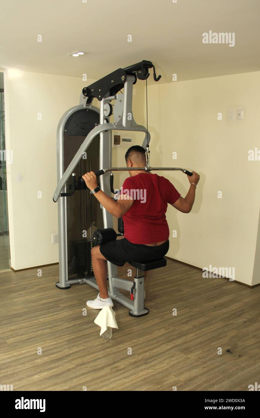 40-year-old dark-skinned Latin man does exercises to strengthen chest ...