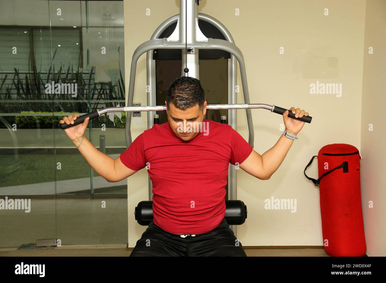 40-year-old dark-skinned Latin man does exercises to strengthen chest ...