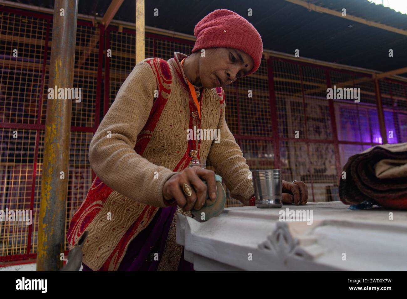 Ayodhya, Uttar Pradesh, India. 17th Jan, 2024. A woman works on a ...