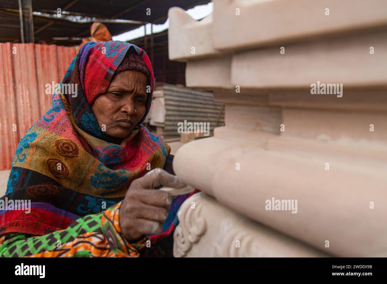 Ayodhya, Uttar Pradesh, India. 17th Jan, 2024. A woman works on a ...