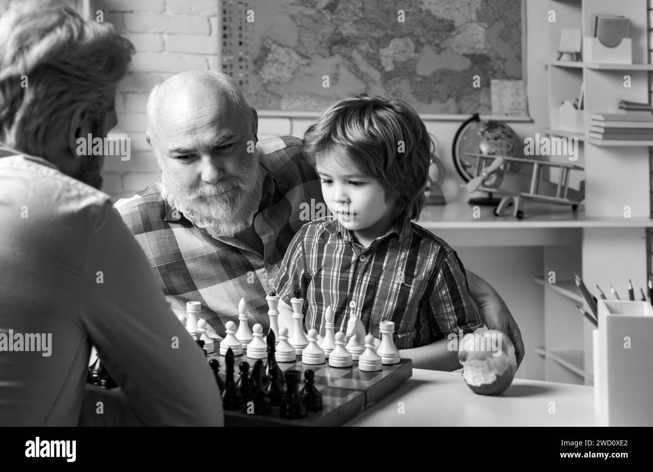 Portrait grandpa and grandson playing chess. Family relationship ...