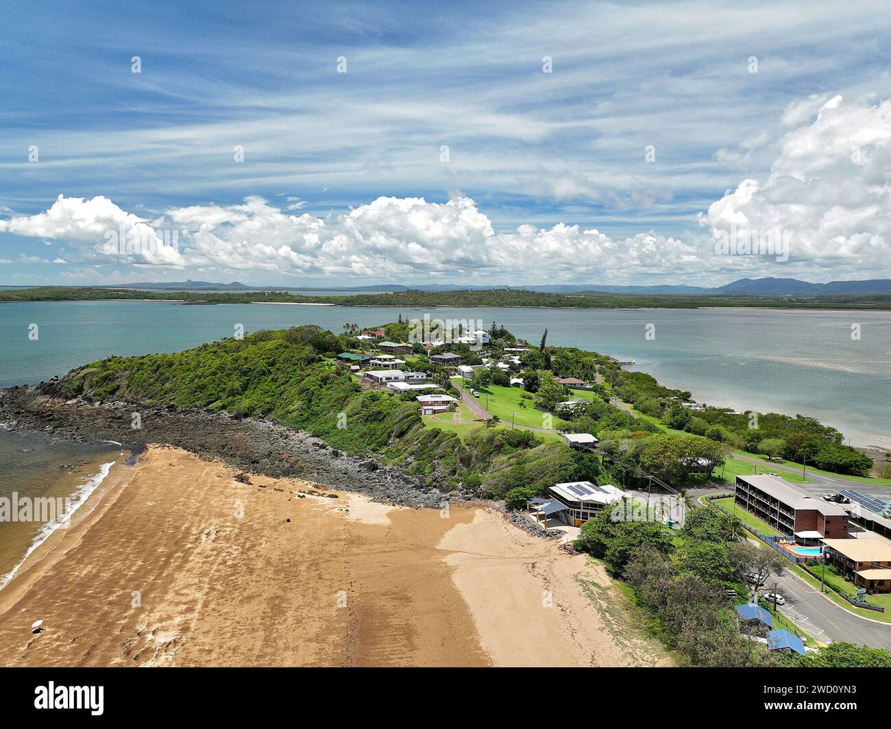 Drone view along beach to hilltop residences Stock Photo - Alamy